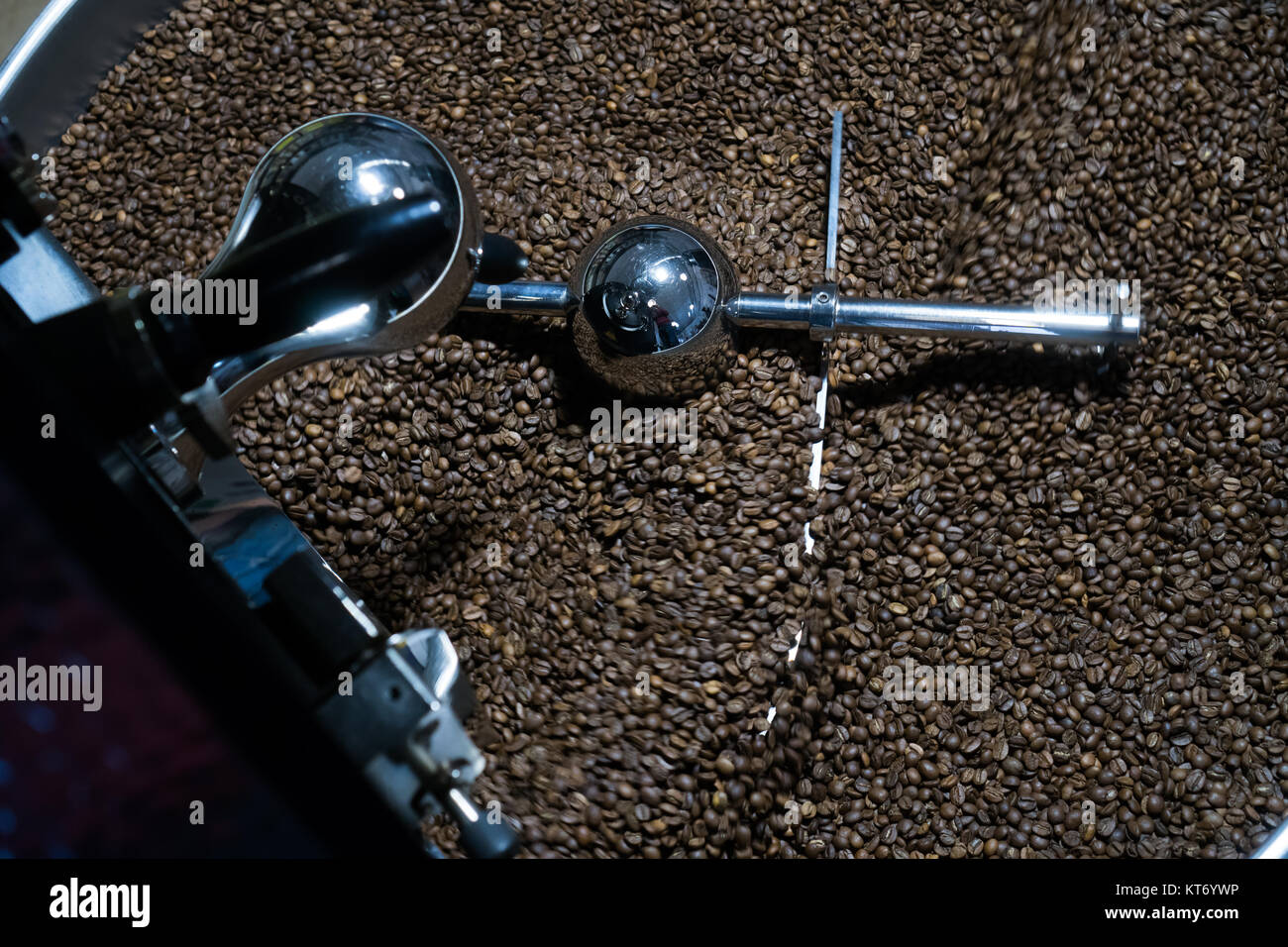 Mixing roasted coffee Stock Photo - Alamy