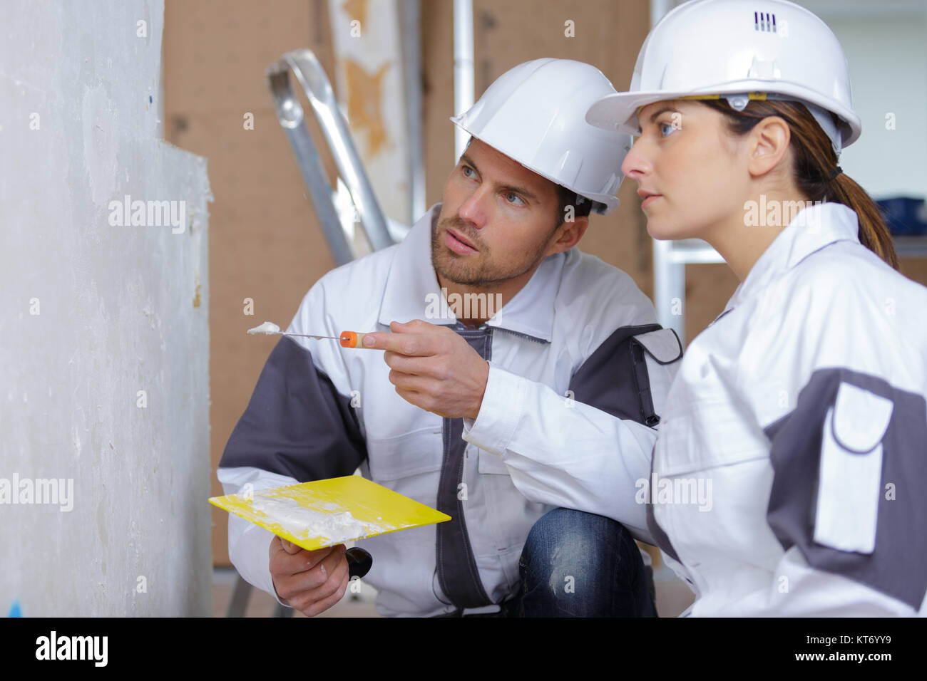 portrait of plasterers team performing wall renovation Stock Photo - Alamy