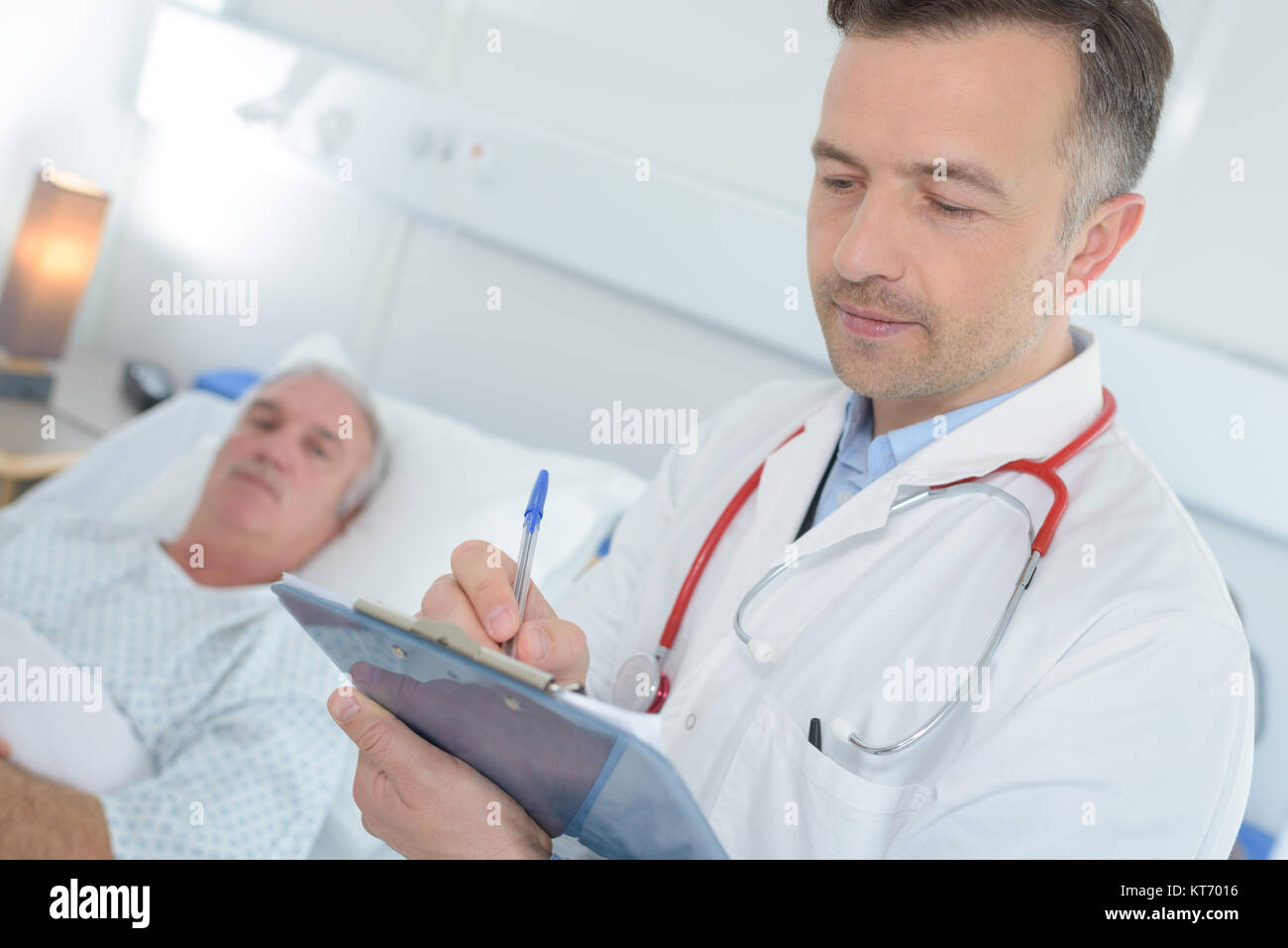 medical staff writing notes on patients condition Stock Photo - Alamy