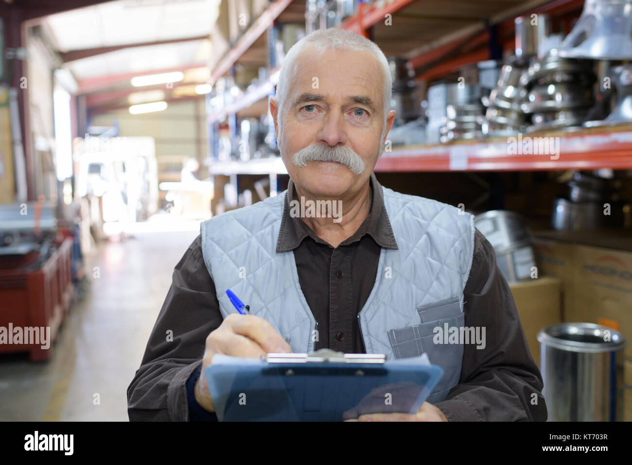 senior worker in a warehouse in a factory Stock Photo - Alamy