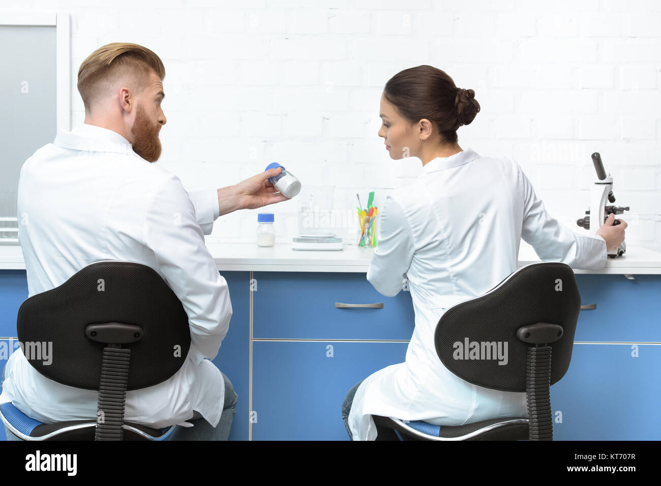 back view of scientists discussing analysis during work in lab Stock ...