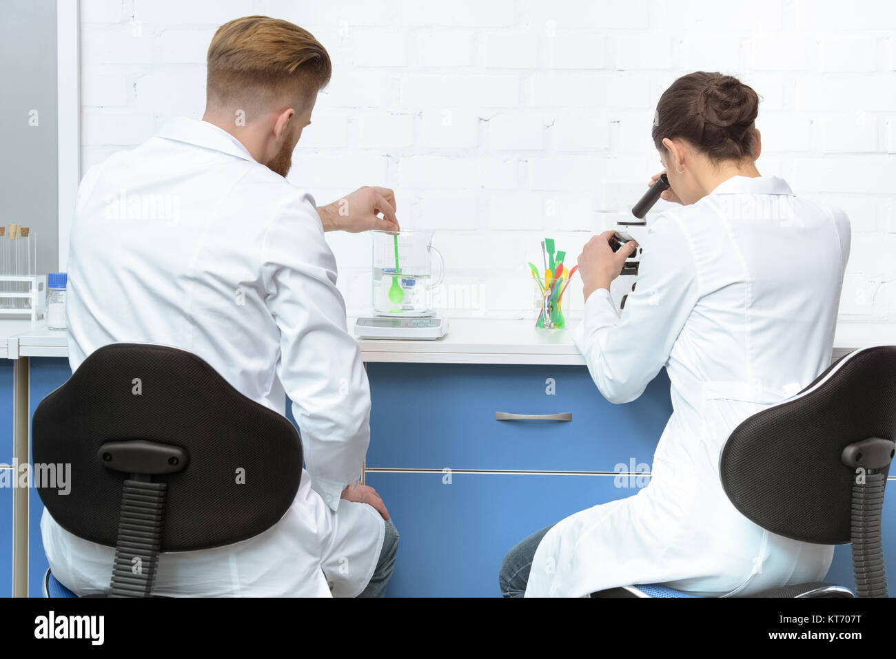 back view of scientists working with chemicals in lab Stock Photo - Alamy