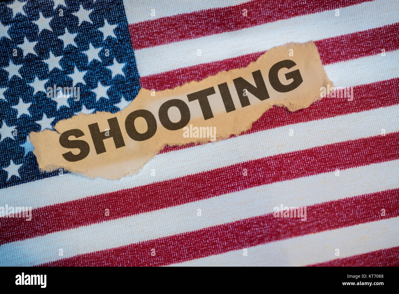 Shooting text word laying on the American Flag Stock Photo - Alamy