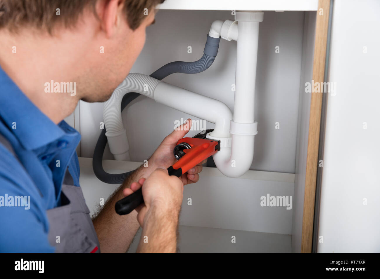 Male Plumber Fixing Sink Pipe Stock Photo - Alamy
