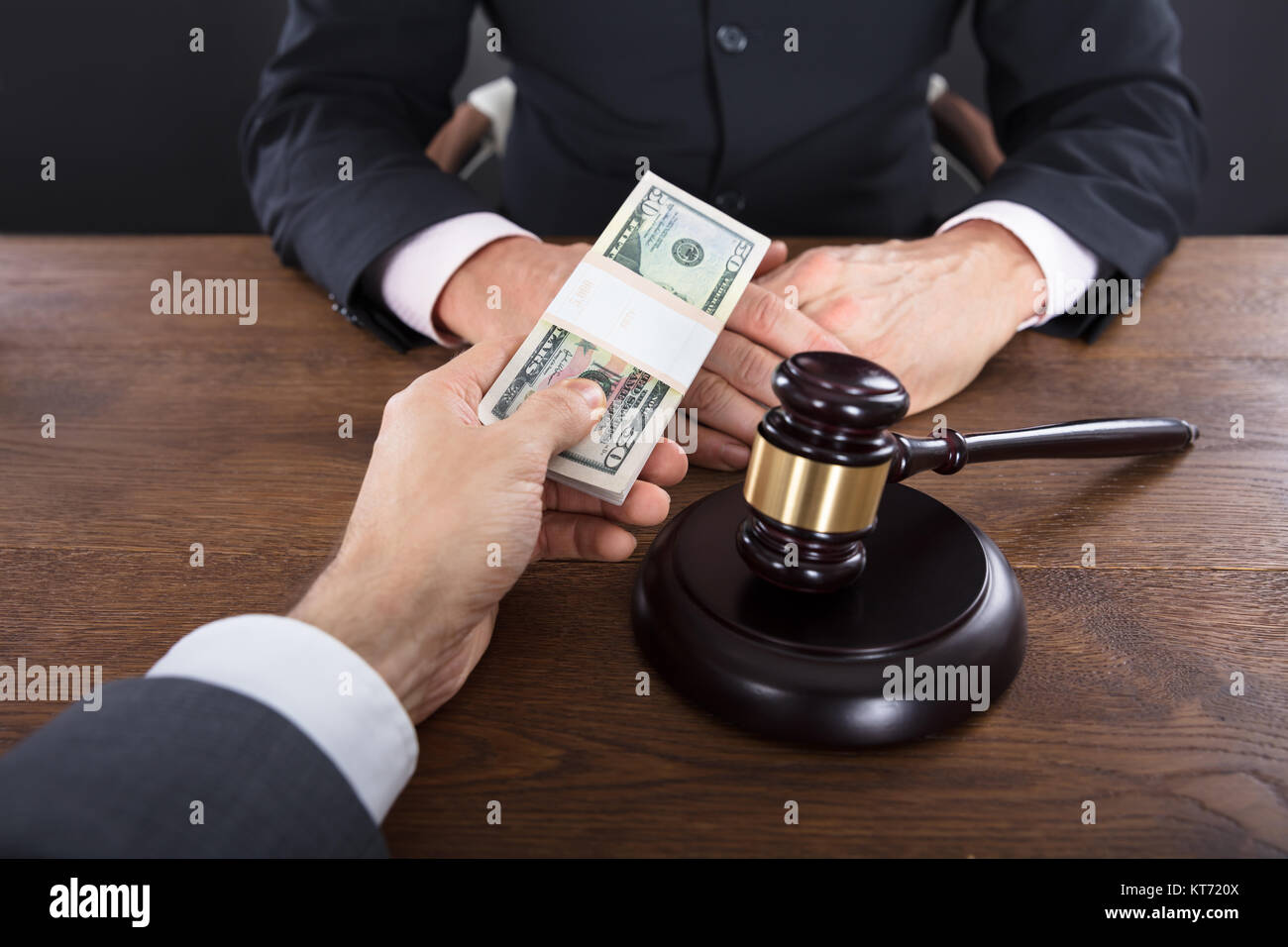 Businessman Giving A Bribe To A Judge Stock Photo - Alamy