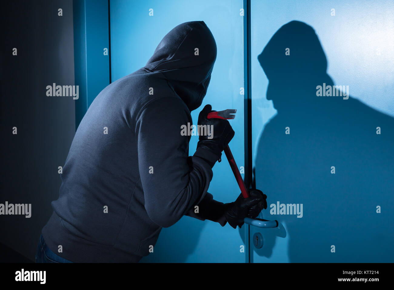 Thief Trying To Break The Door Stock Photo - Alamy