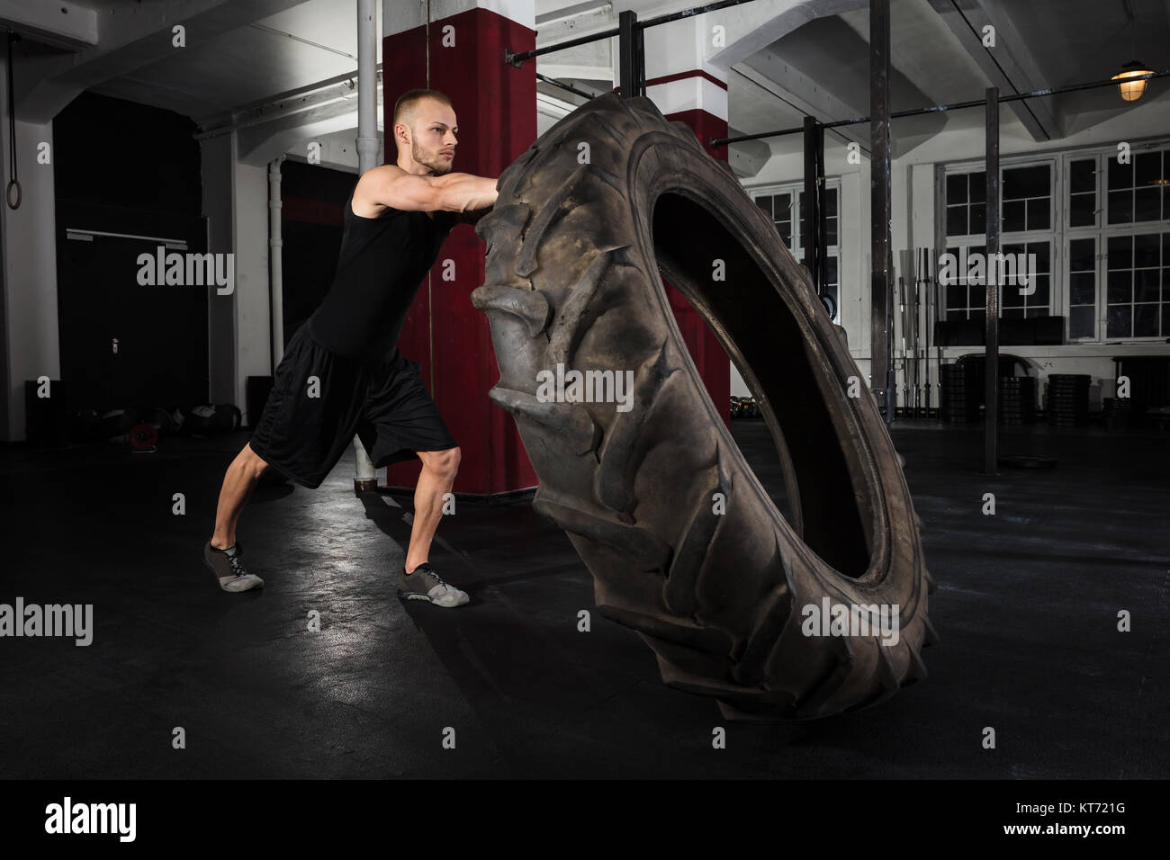 Young Man Pushing Tire Stock Photo - Alamy