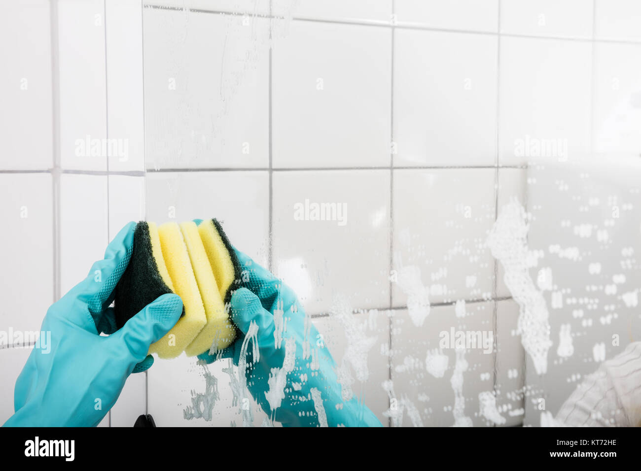Female Janitor Cleaning Bathroom Mirror Stock Photo - Alamy