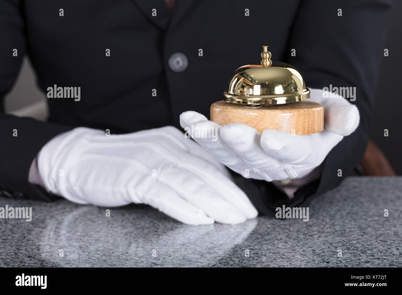Waiter Holding Service Bell Stock Photo - Alamy