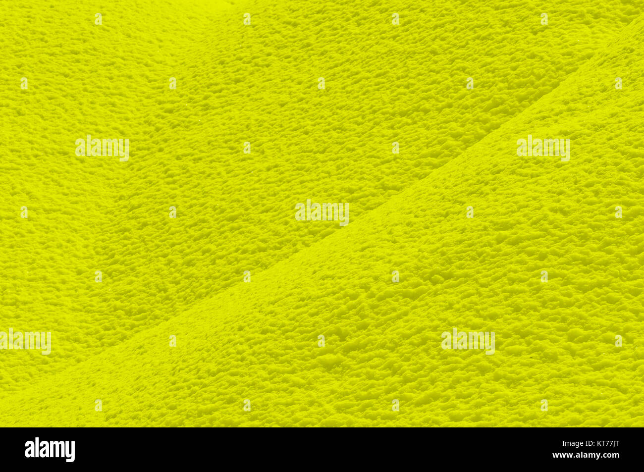 Yellow colored snow surface as background Stock Photo - Alamy