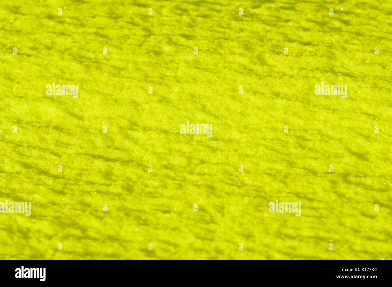 Yellow colored snow surface as background Stock Photo - Alamy