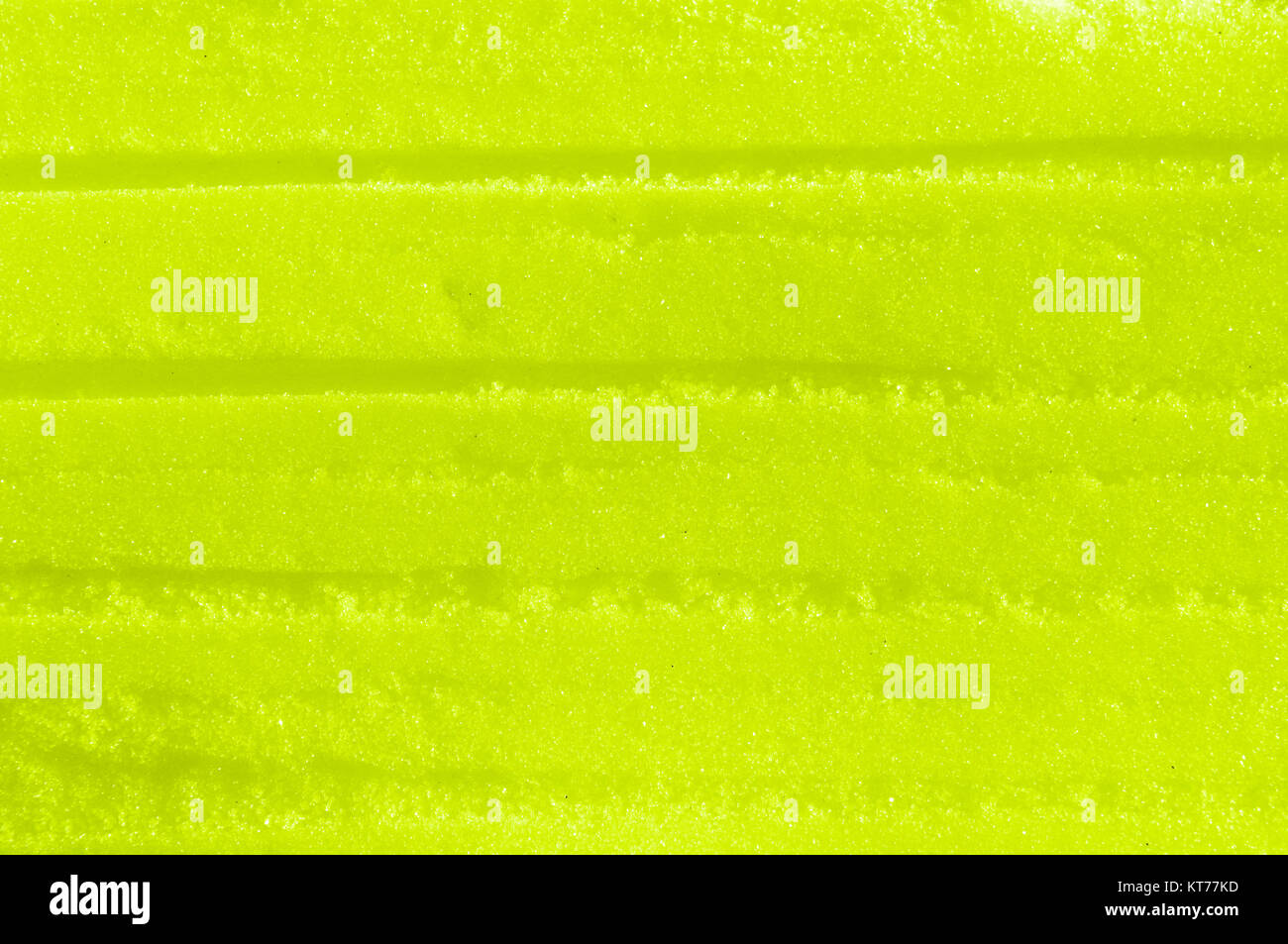 Yellow colored snow surface as background Stock Photo - Alamy