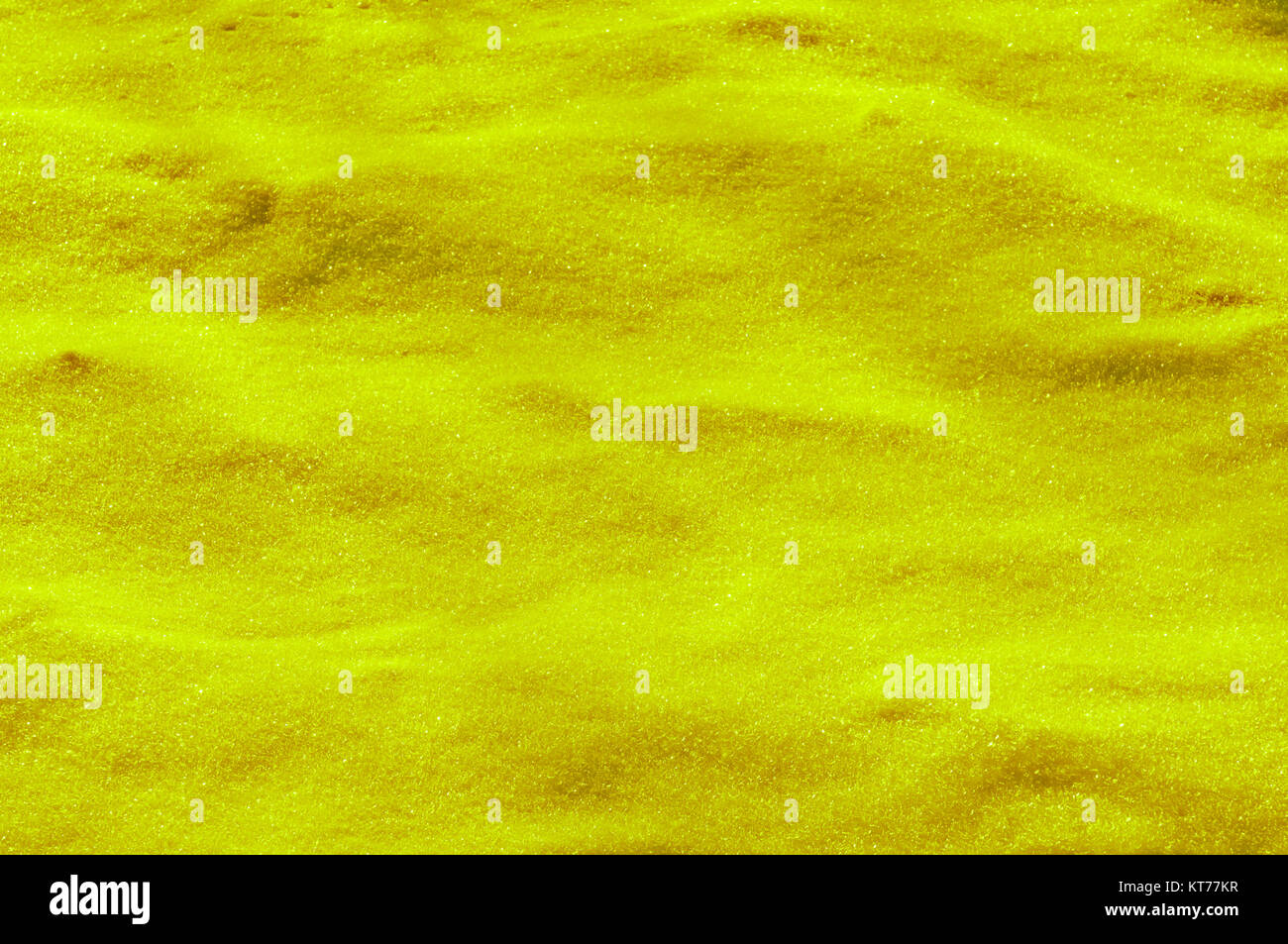 Yellow colored snow surface as background Stock Photo - Alamy