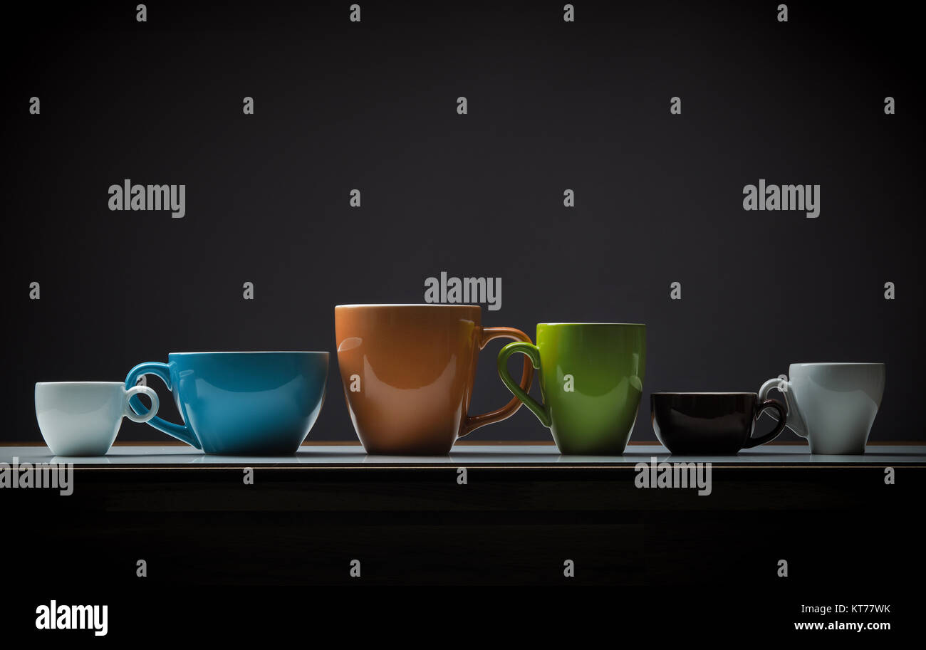Assortment of a different coffee cups on a table Stock Photo - Alamy