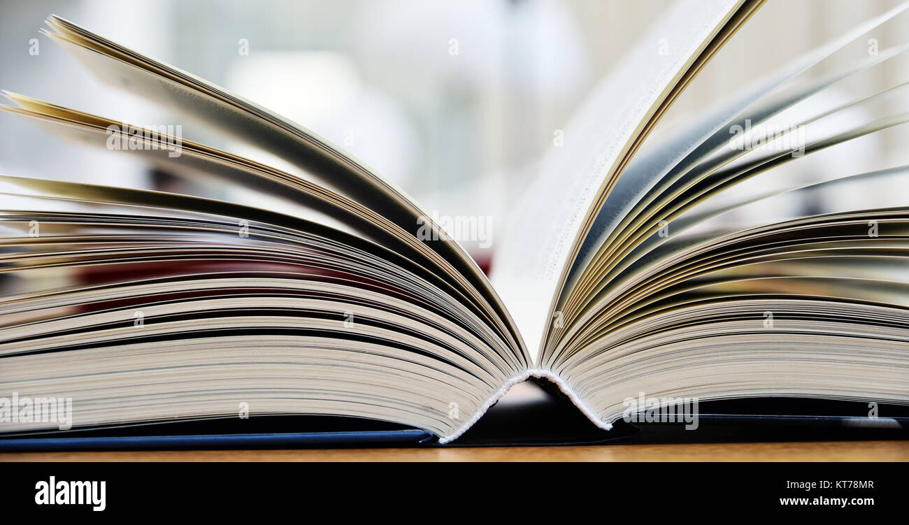 Hardcover book lying on the table in a library Stock Photo - Alamy