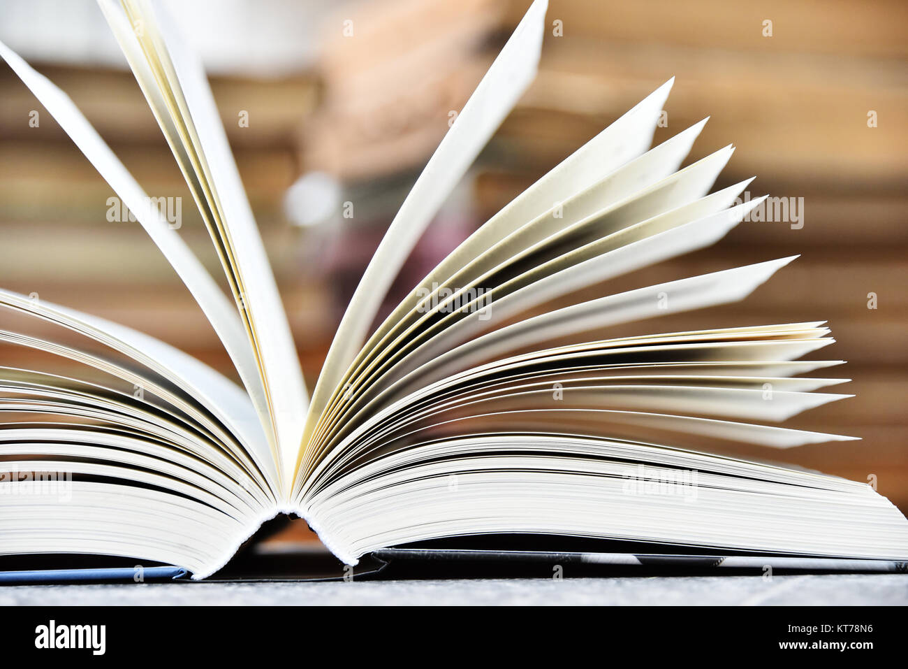 Hardcover book lying on the table in the library Stock Photo - Alamy
