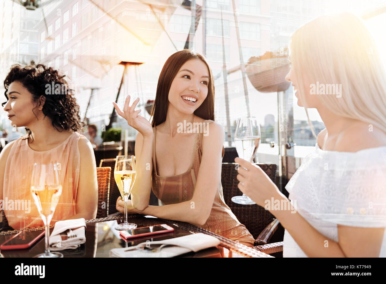 Positive young woman talking to her friend Stock Photo - Alamy