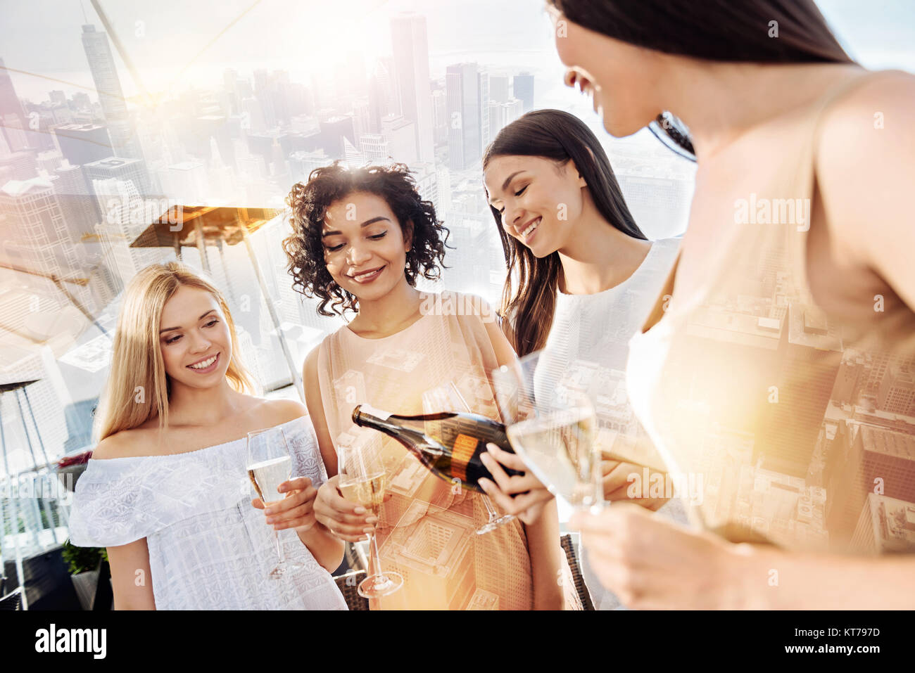 Joyful happy women drinking alcohol together Stock Photo - Alamy