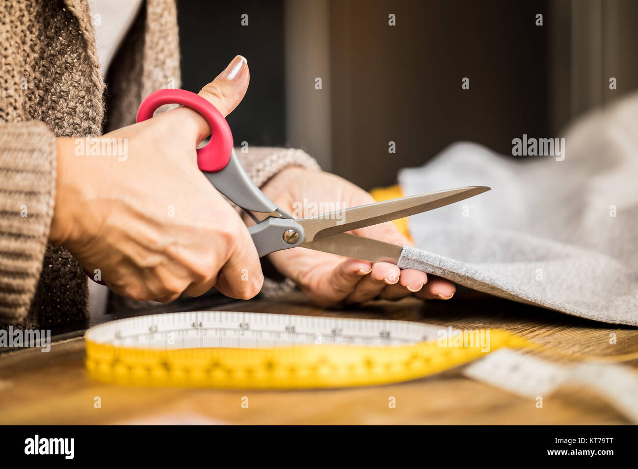 Woman cutting fabric Stock Photo - Alamy