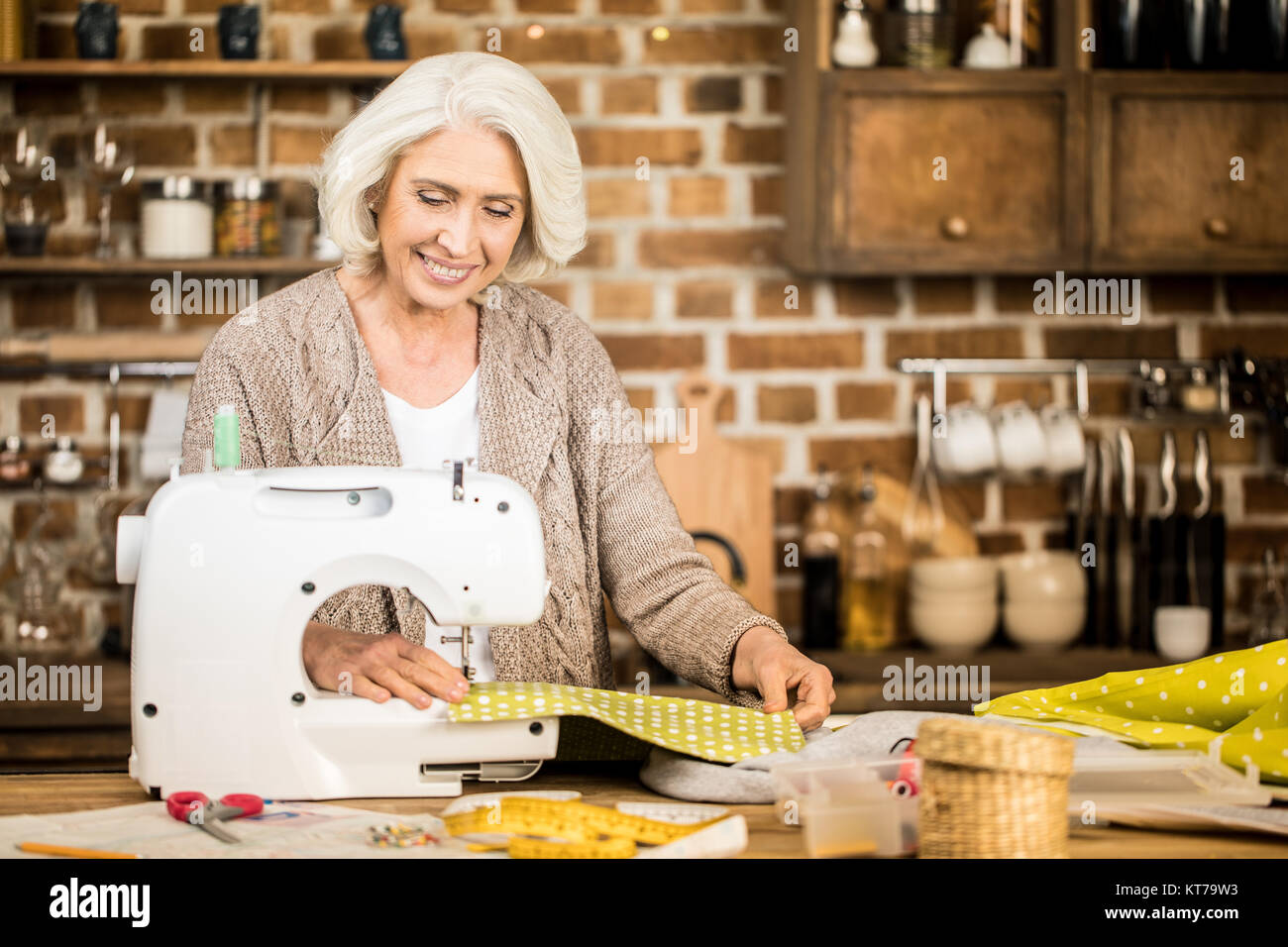 Woman using sewing machine Stock Photo - Alamy