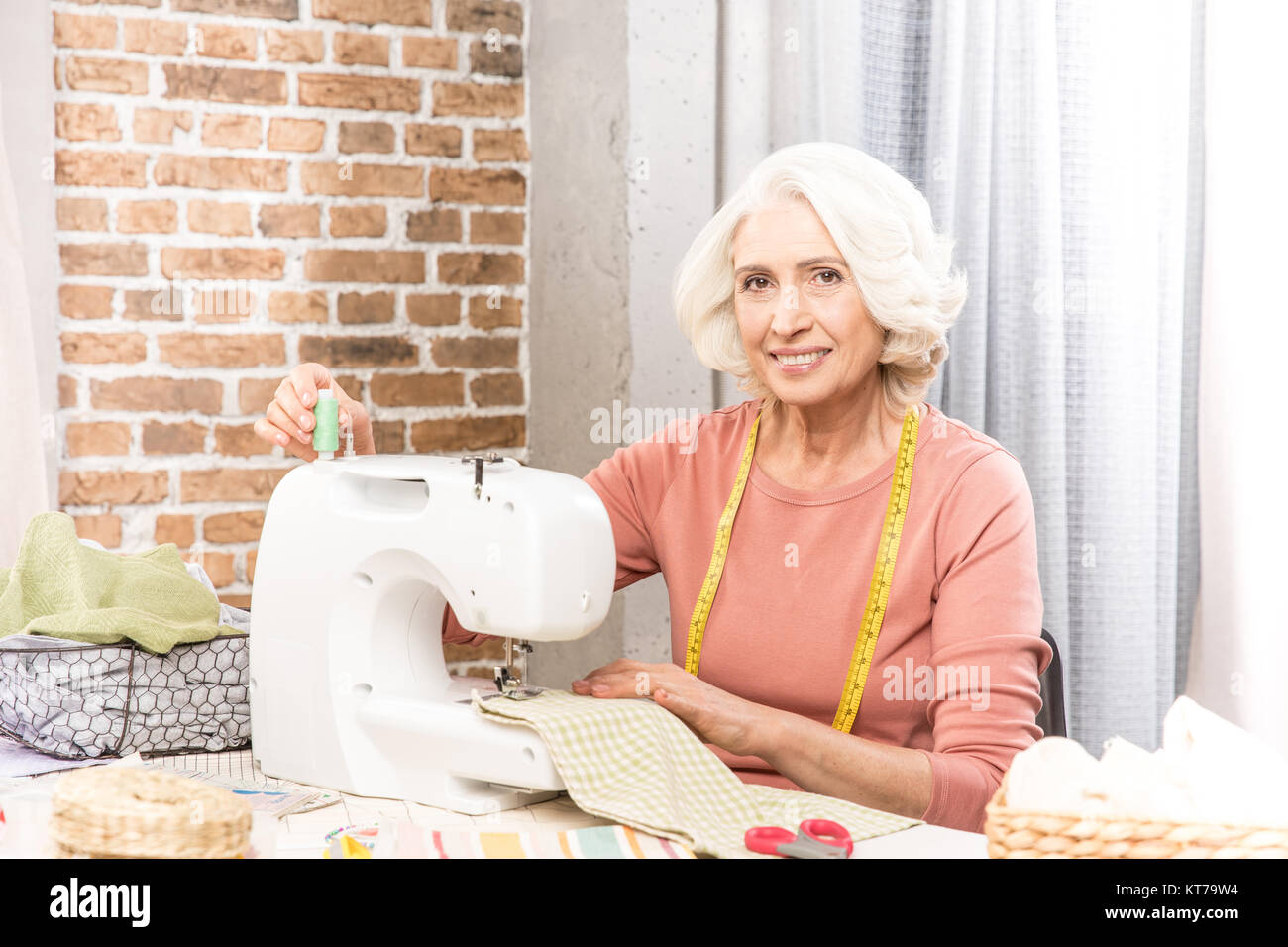 Woman with sewing machine Stock Photo - Alamy