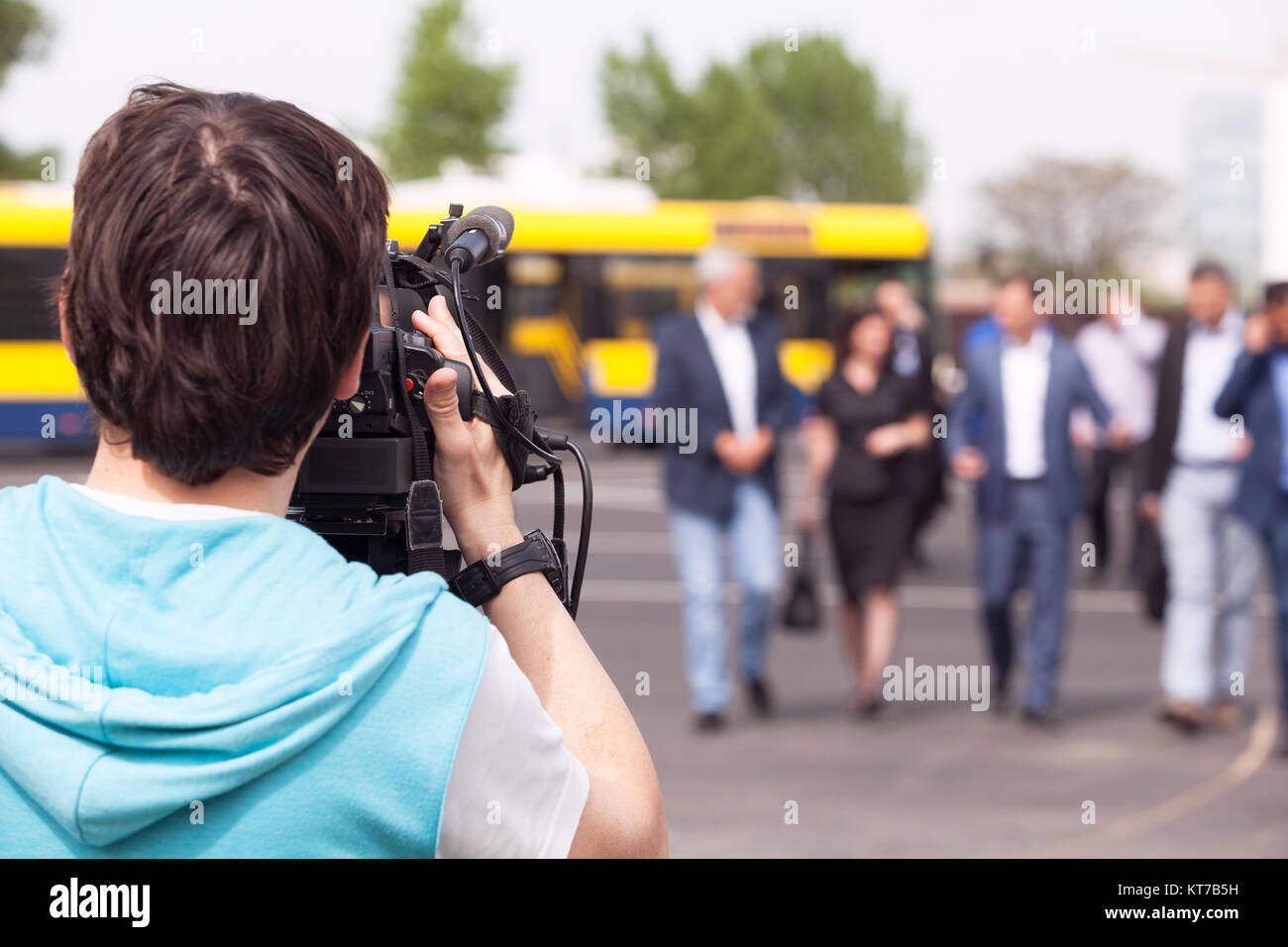 Cameraman filming unrecognizable group of people Stock Photo - Alamy
