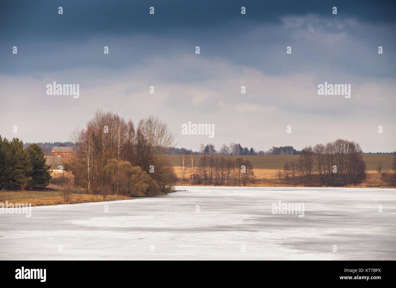 Early spring. Mud season. Lake under ice and snow melting Stock Photo ...