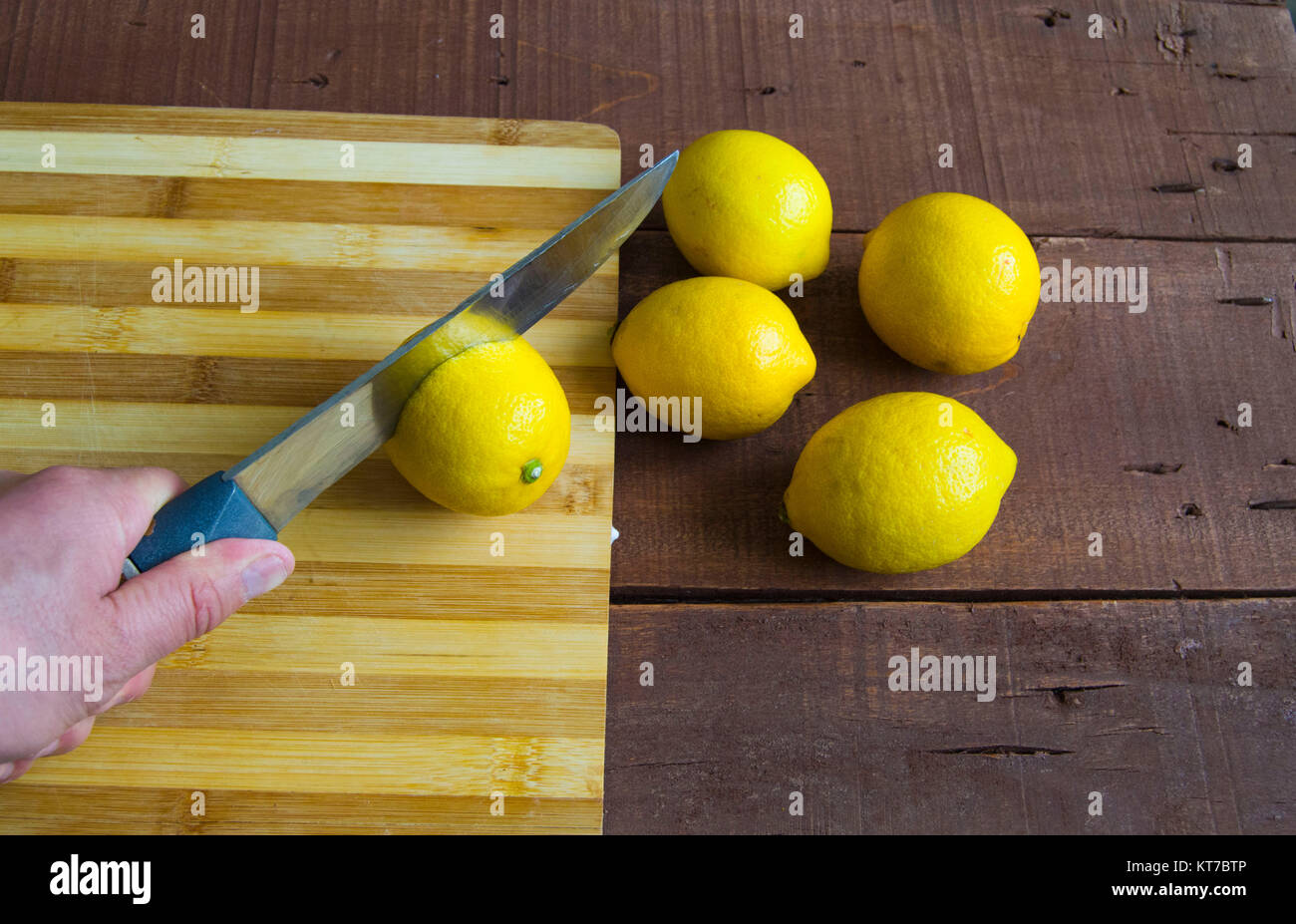 Knife and lemon pictures ready to cut on the table Fresh juicy lemon on ...