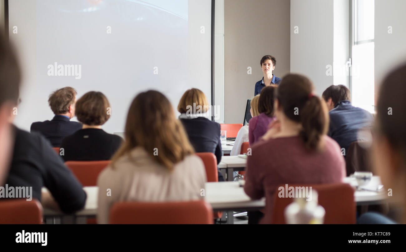 Woman giving presentation in lecture hall at university Stock Photo - Alamy