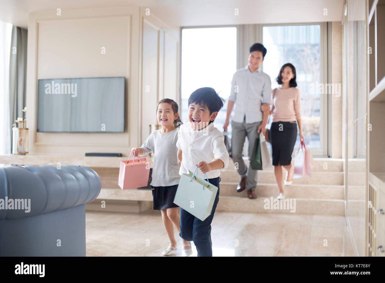 Young family coming back from shopping Stock Photo - Alamy