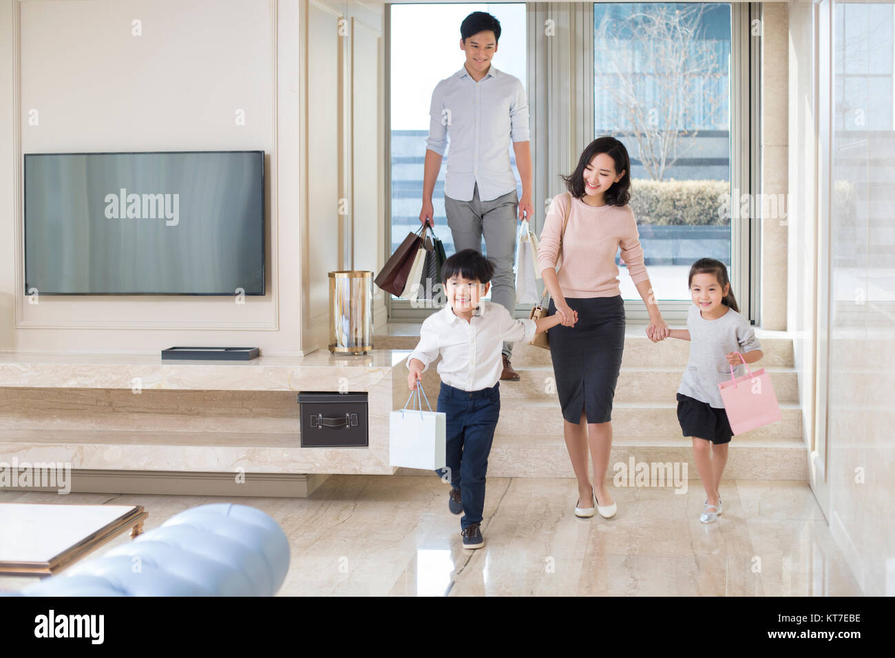Young family coming back from shopping Stock Photo - Alamy