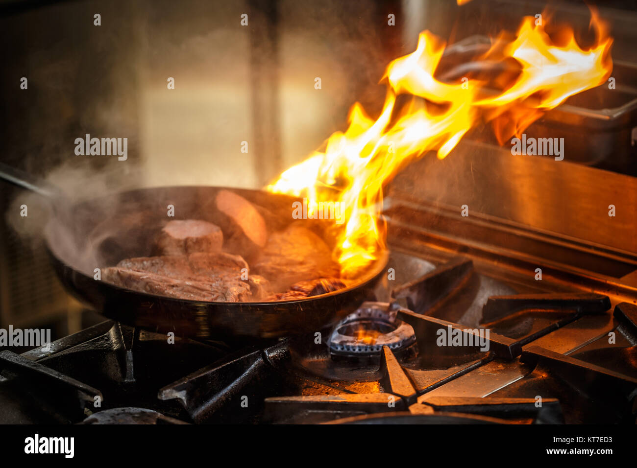 Piece of meat in fire Stock Photo - Alamy