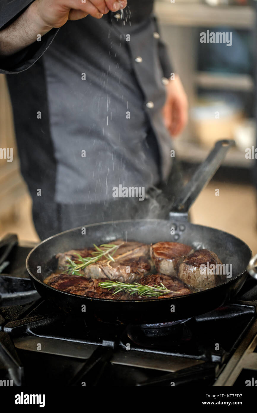 Chef putting salt Stock Photo - Alamy