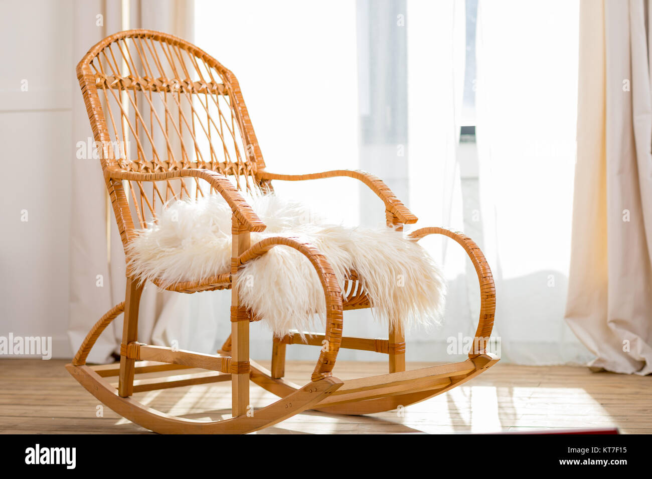 rocking chair with woolly rug in bright room with sunlight Stock Photo ...