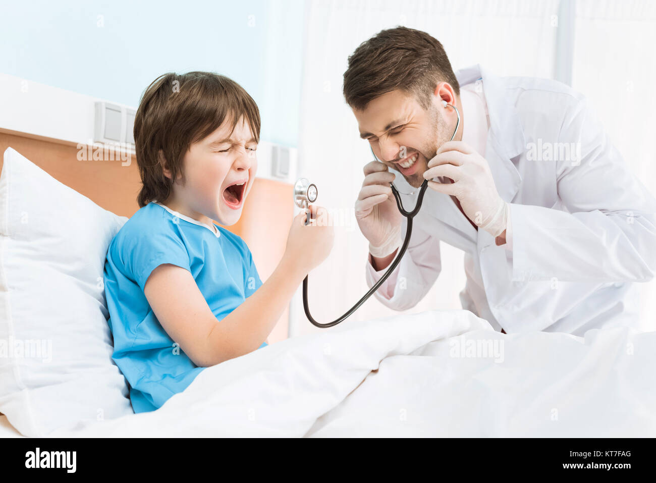 little boy screaming into doctor's stethoscope in hospital Stock Photo ...