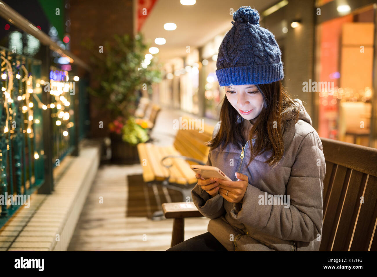 Woman using cellphone at night Stock Photo - Alamy
