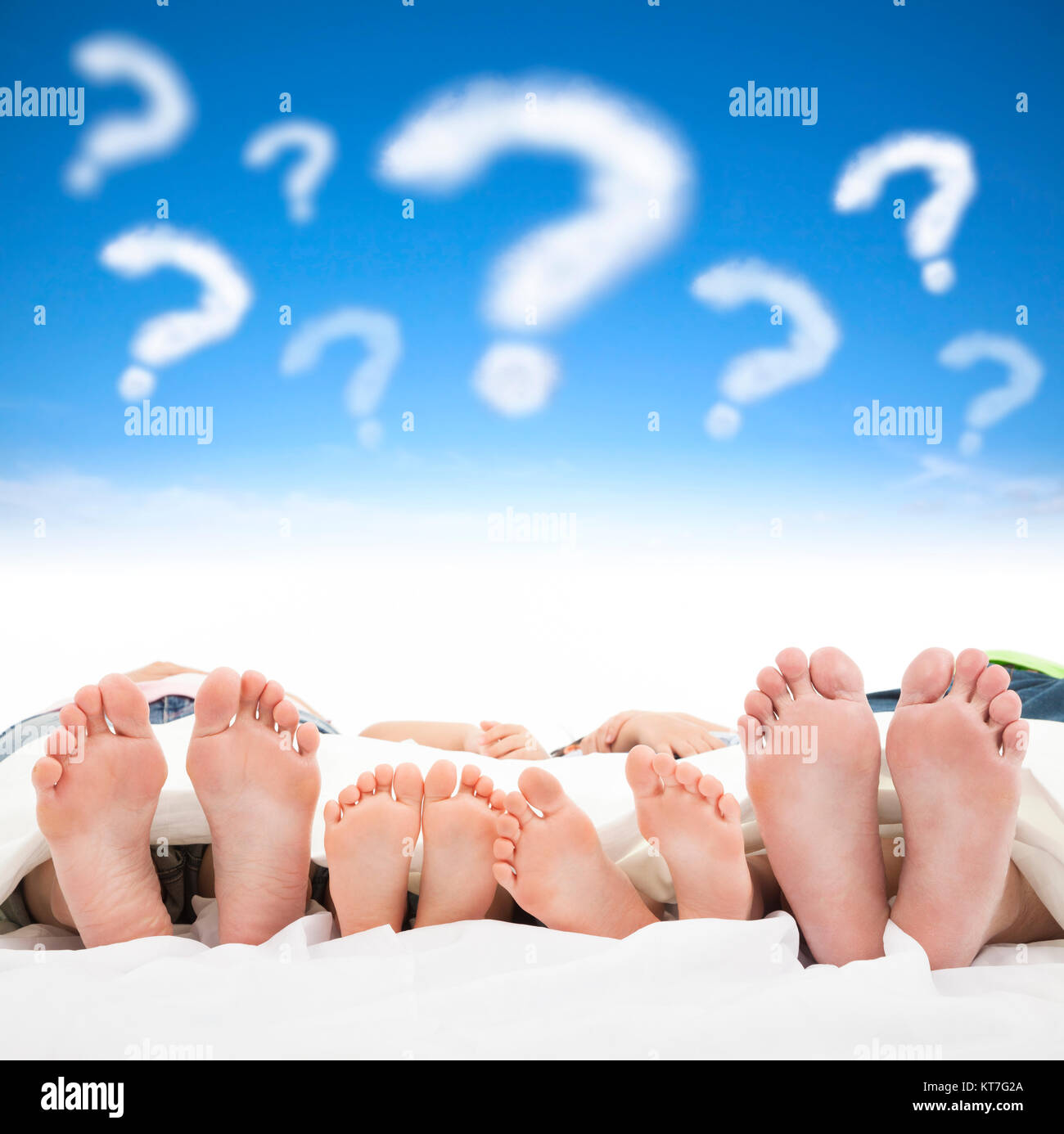 family sleeping on the bed with question mark concept Stock Photo - Alamy