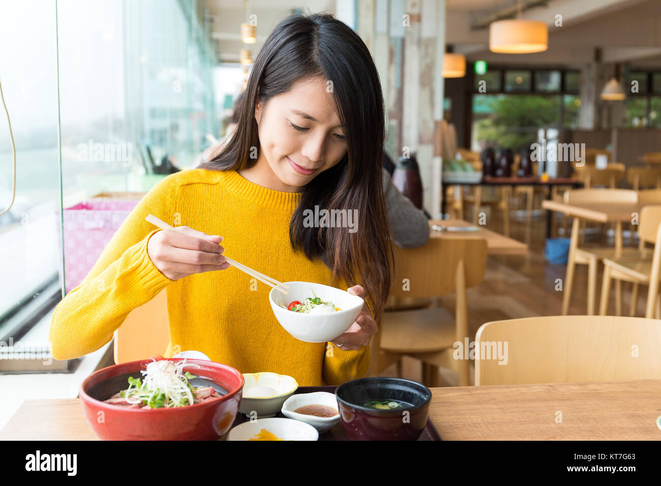 Woman having lunch Stock Photo - Alamy