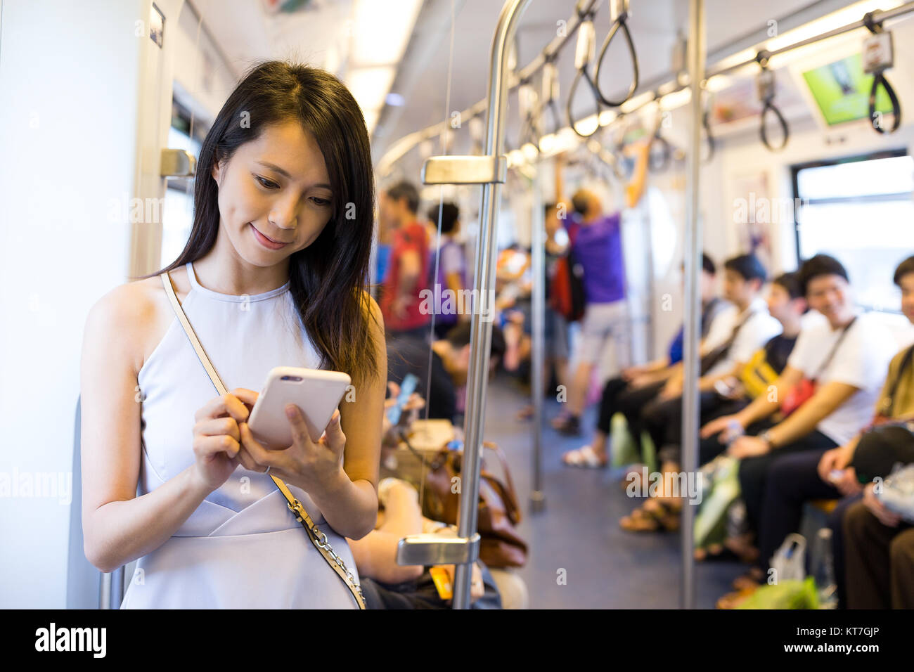 Woman using cellphone inside train compartment Stock Photo - Alamy