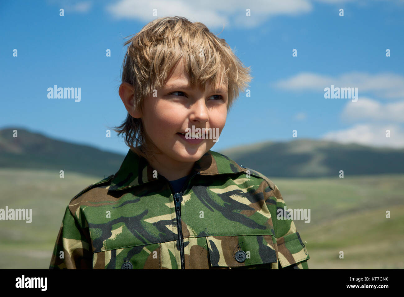 Boy camouflage outdoors in the mountains Stock Photo - Alamy