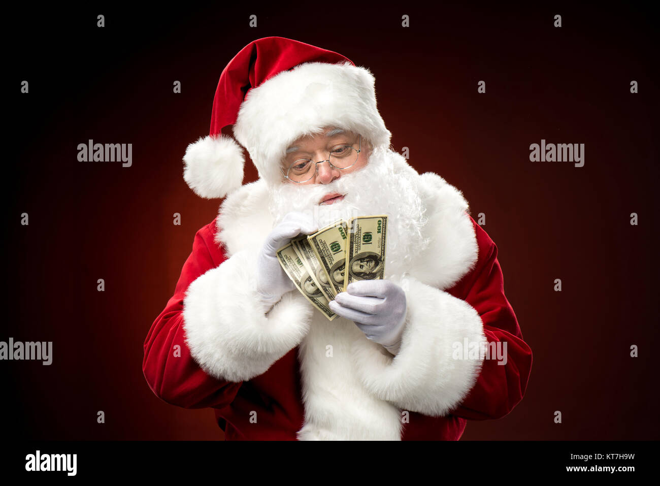 Santa Claus counting dollar banknotes Stock Photo - Alamy