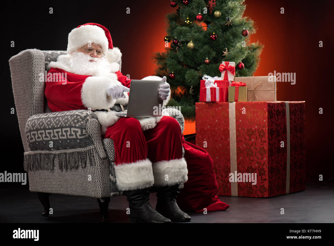 Santa Claus using laptop Stock Photo - Alamy