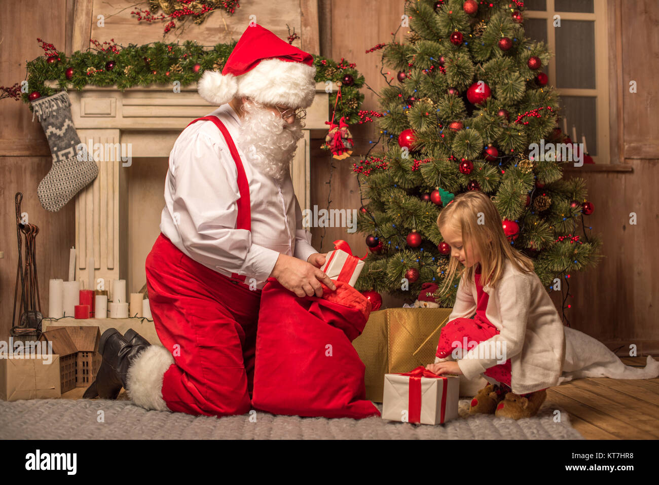 Santa Claus showing Christmas presents Stock Photo - Alamy