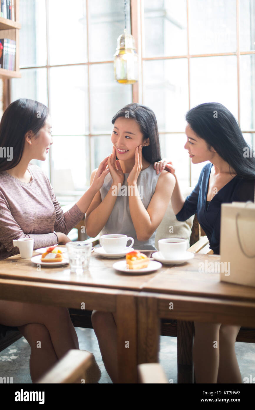 Best female friends drinking coffee in café Stock Photo - Alamy
