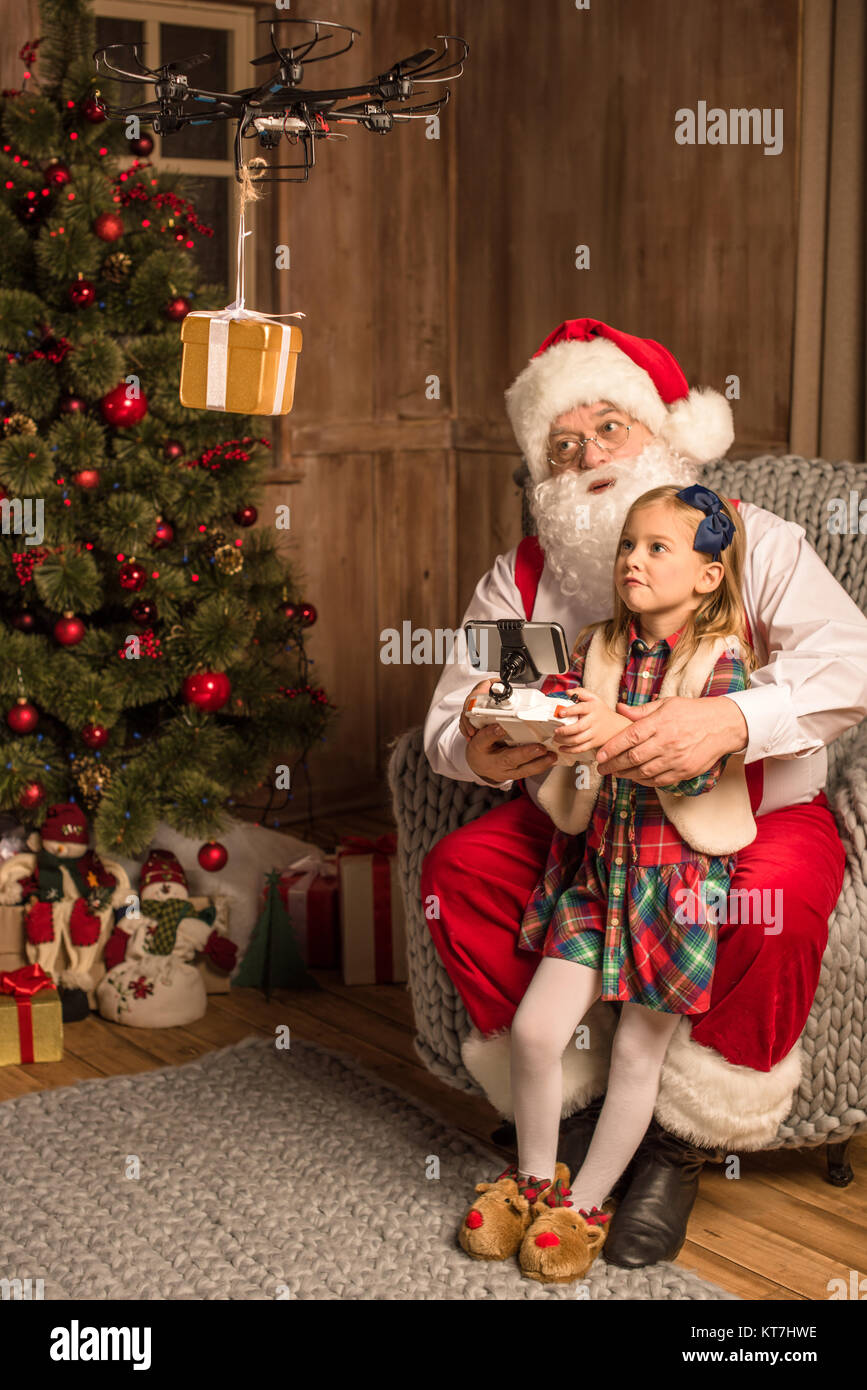 Santa with kid using hexacopter drone Stock Photo - Alamy