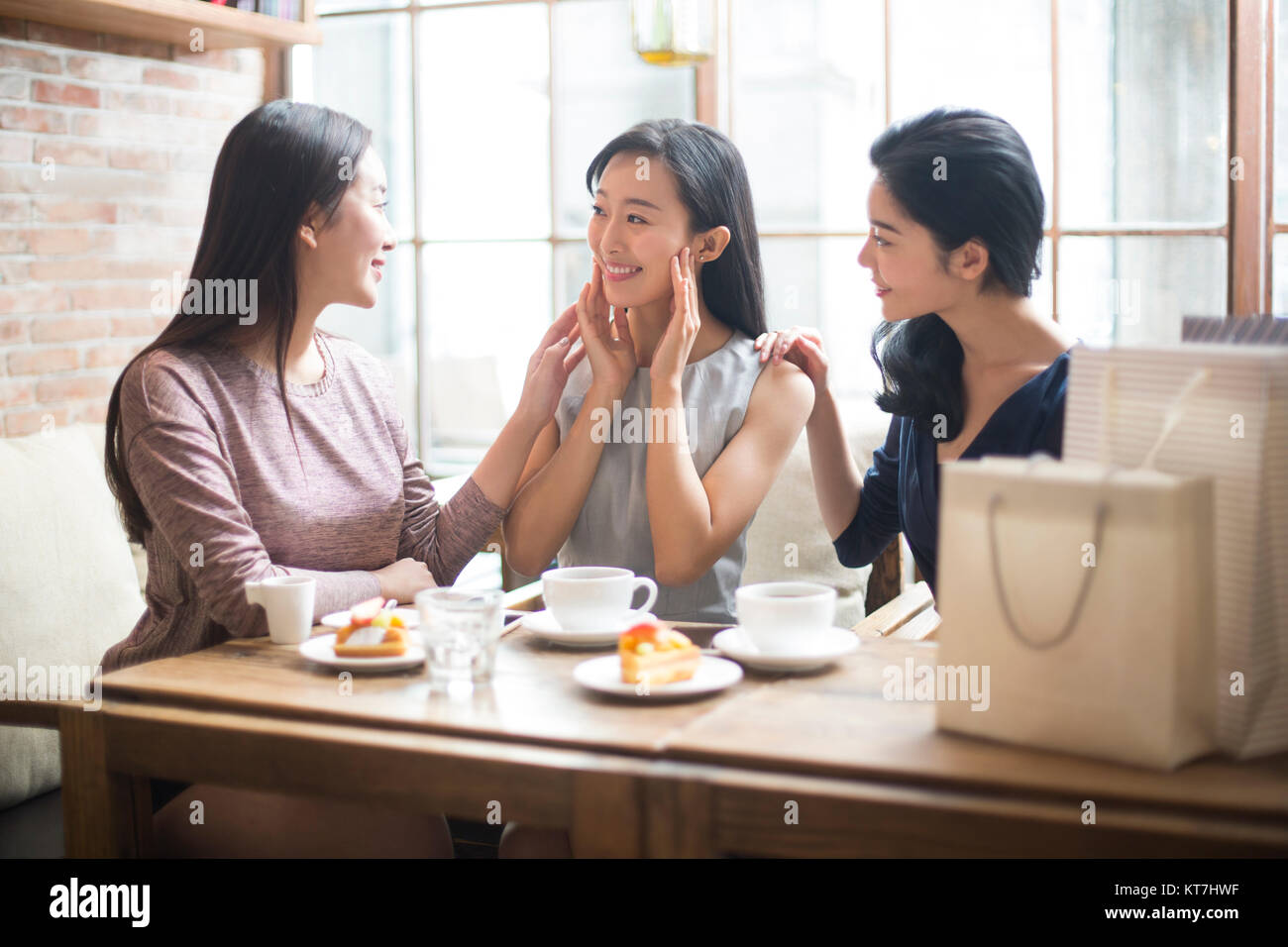 Best female friends drinking coffee in café Stock Photo - Alamy