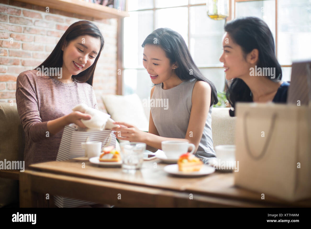 Best female friends drinking coffee in café Stock Photo - Alamy