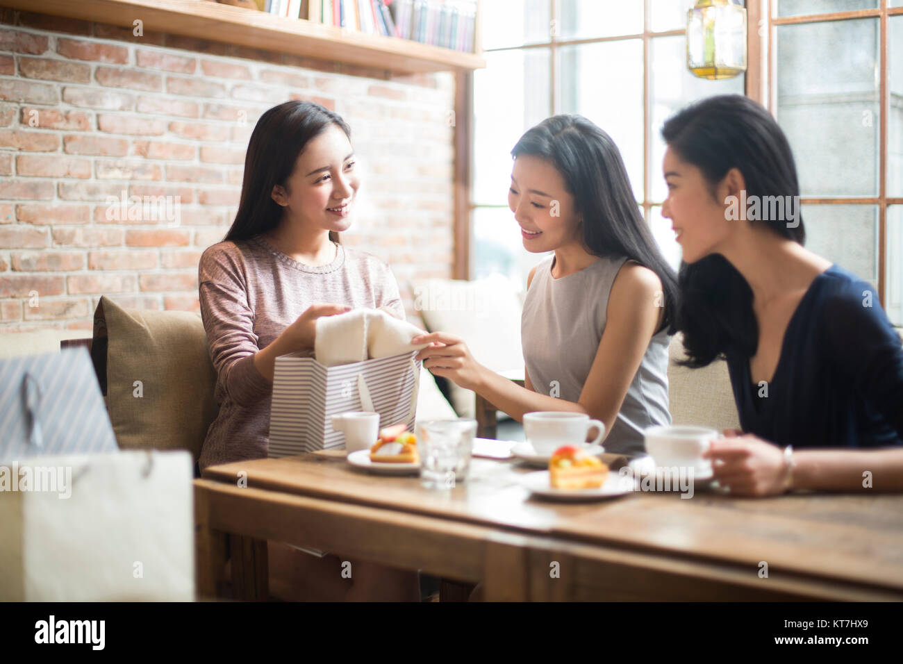 Best female friends drinking coffee in café Stock Photo - Alamy