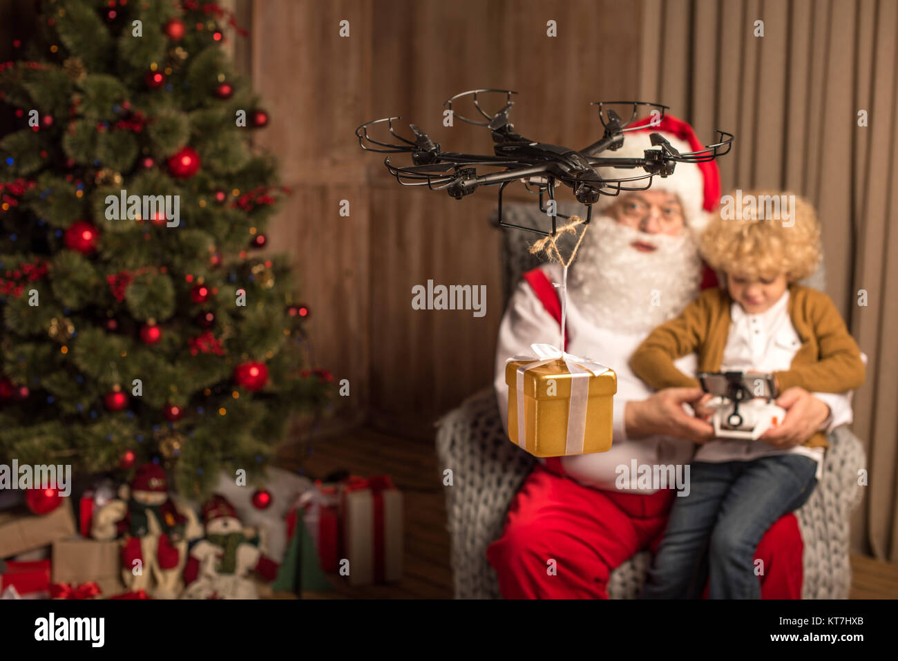 Santa with kid using hexacopter drone Stock Photo - Alamy