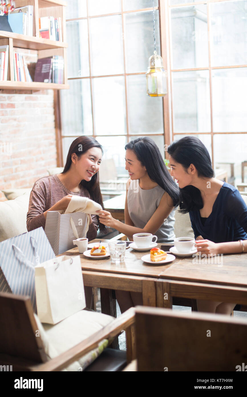 Best female friends drinking coffee in café Stock Photo - Alamy